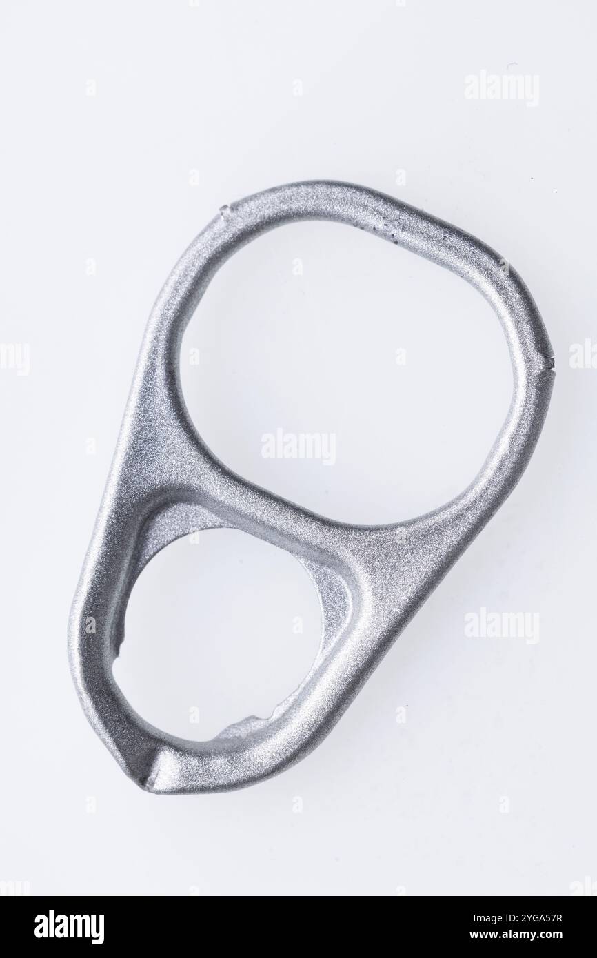 A closeup view of a silver aluminum can pull tab with a textured ...