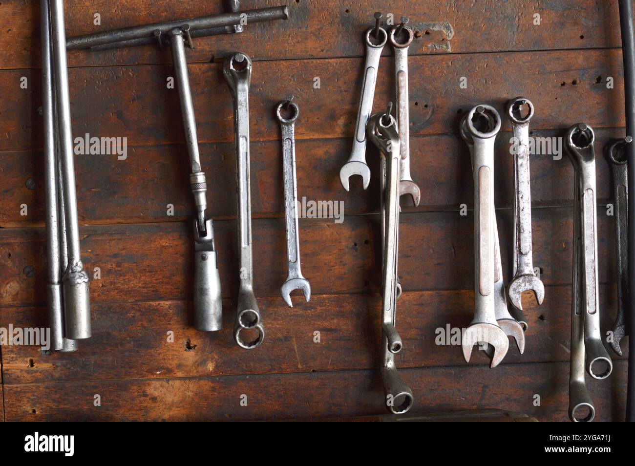 dirty and greasy toolset keys hanging on the wall Stock Photo - Alamy