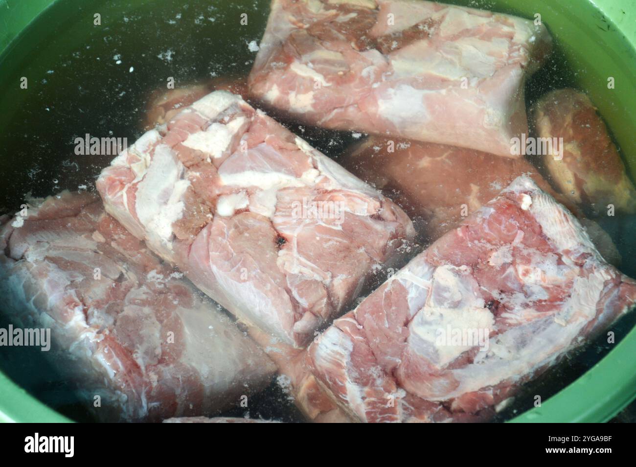frozen beef marinated with water in a basin Stock Photo - Alamy