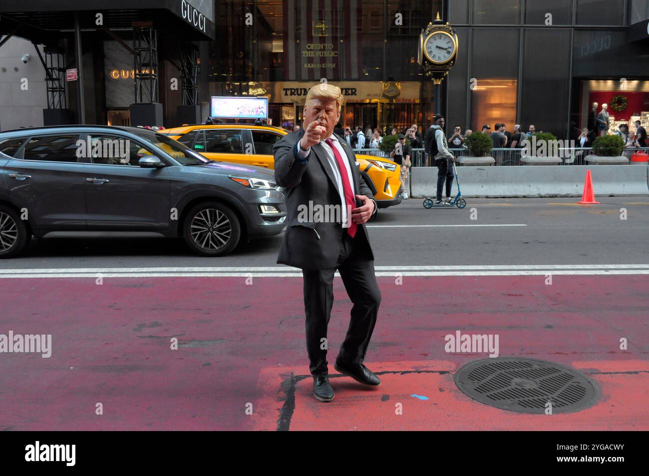 A Donald Trump impersonator wearing a Trump mask poses on the street ...