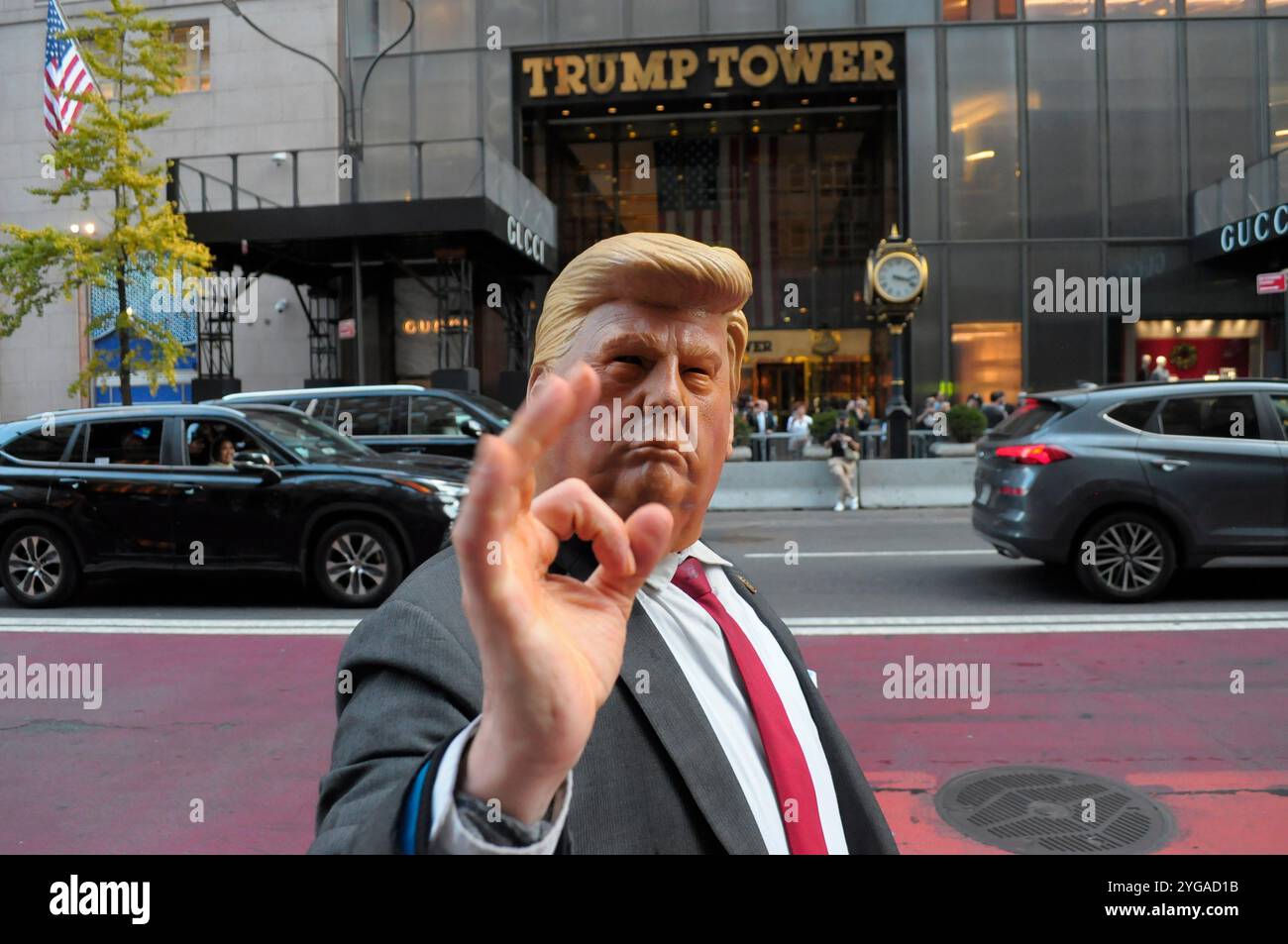 A Donald Trump impersonator wearing a Trump mask poses on the street ...