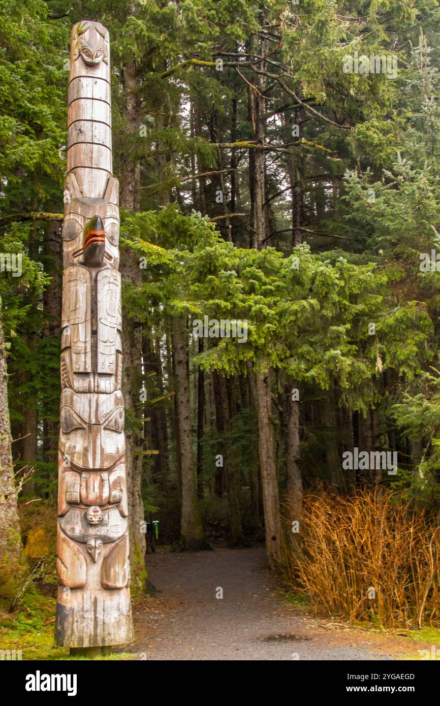 USA, Alaska, Sitka. Totem pole and trail in Sitka National Historical ...