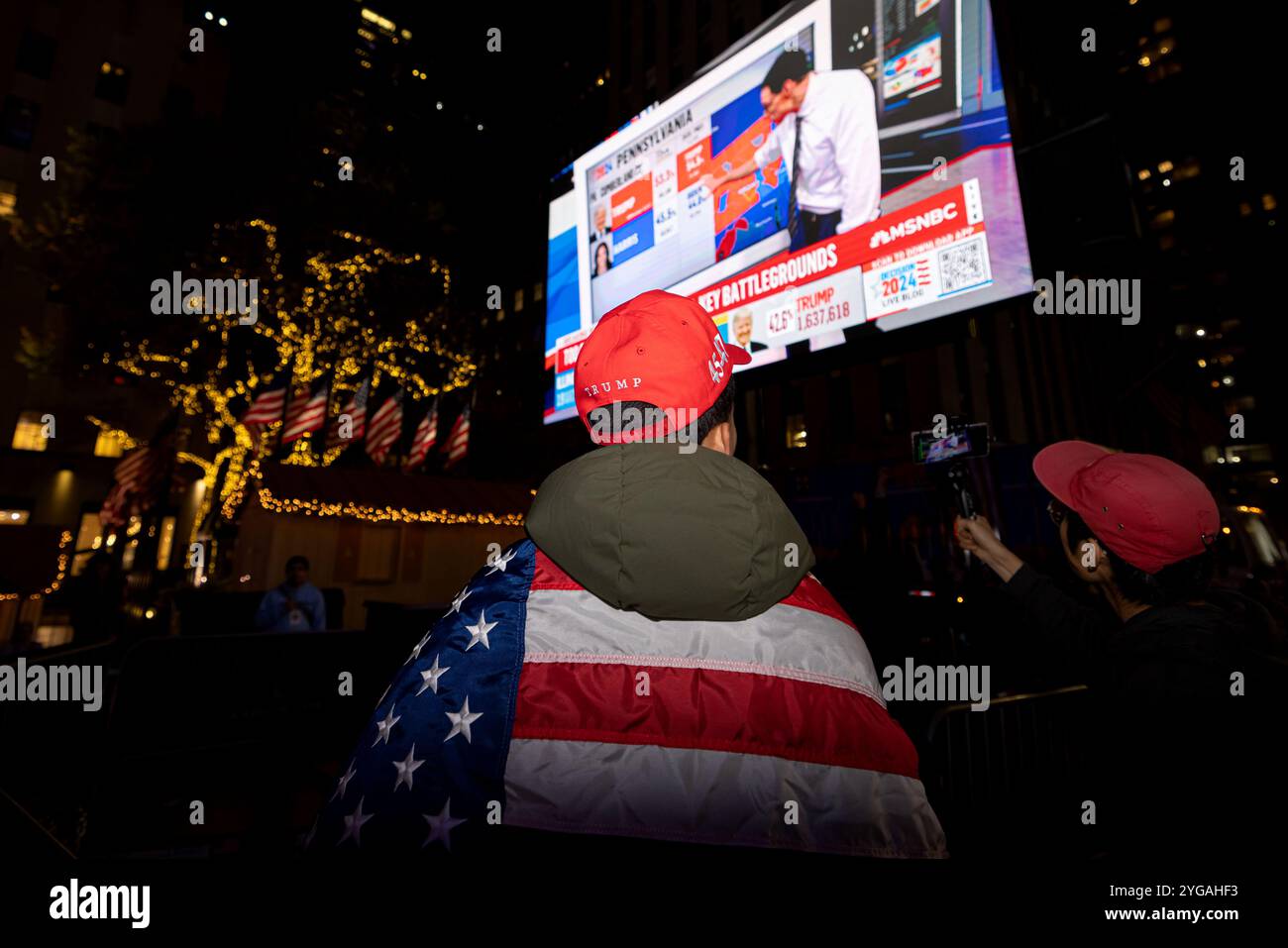 Onlookers watch as the 2024 U.S. Presidential election results are ...