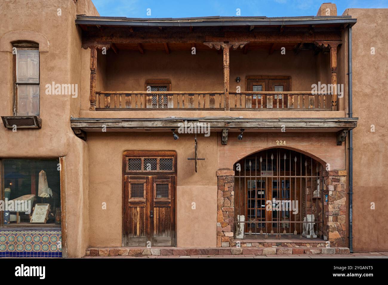 Usa, New Mexico, Santa Fe. A rustic wooden door, stonework, and wrought ...