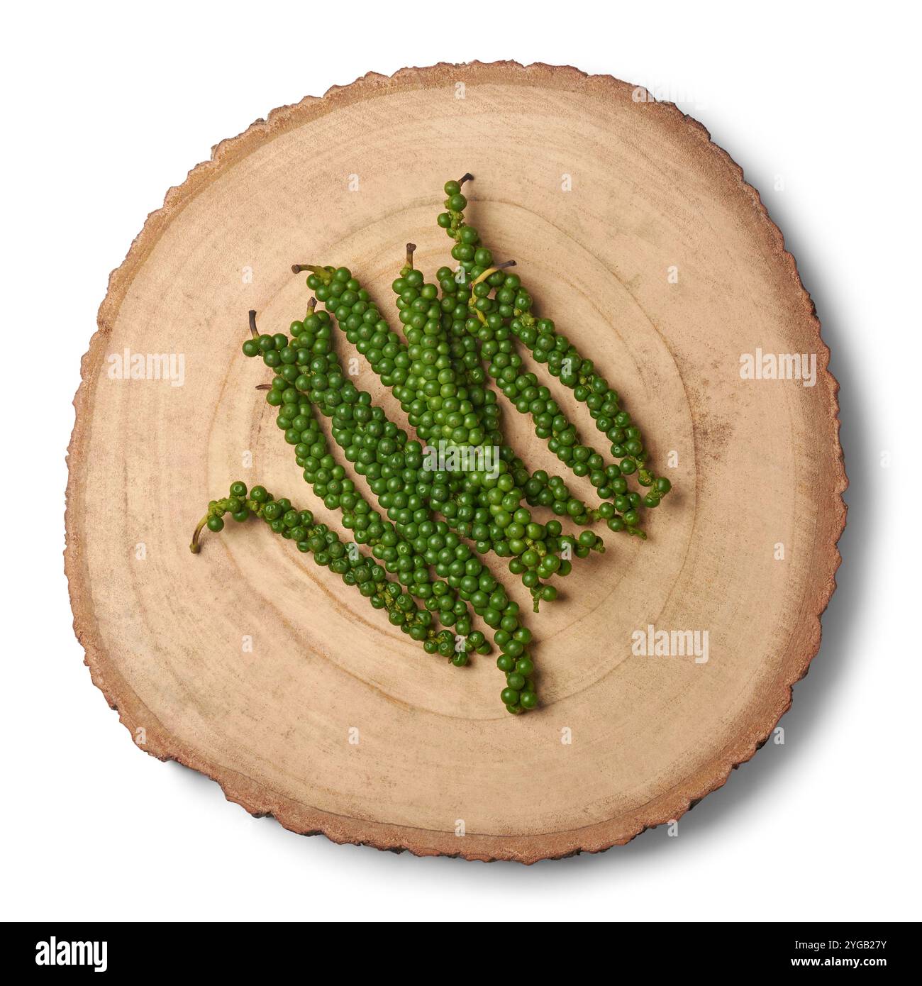 maturing black peppercorns on wooden tray isolated white background ...