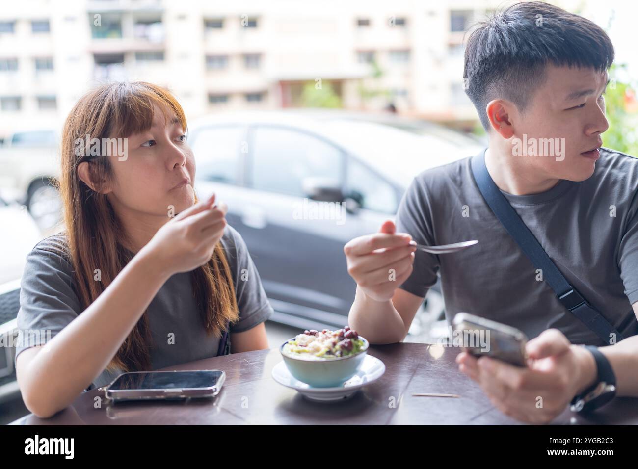 June 2024. A Chinese-Malaysian couple in their 30s chat while eating chendol at a local ...