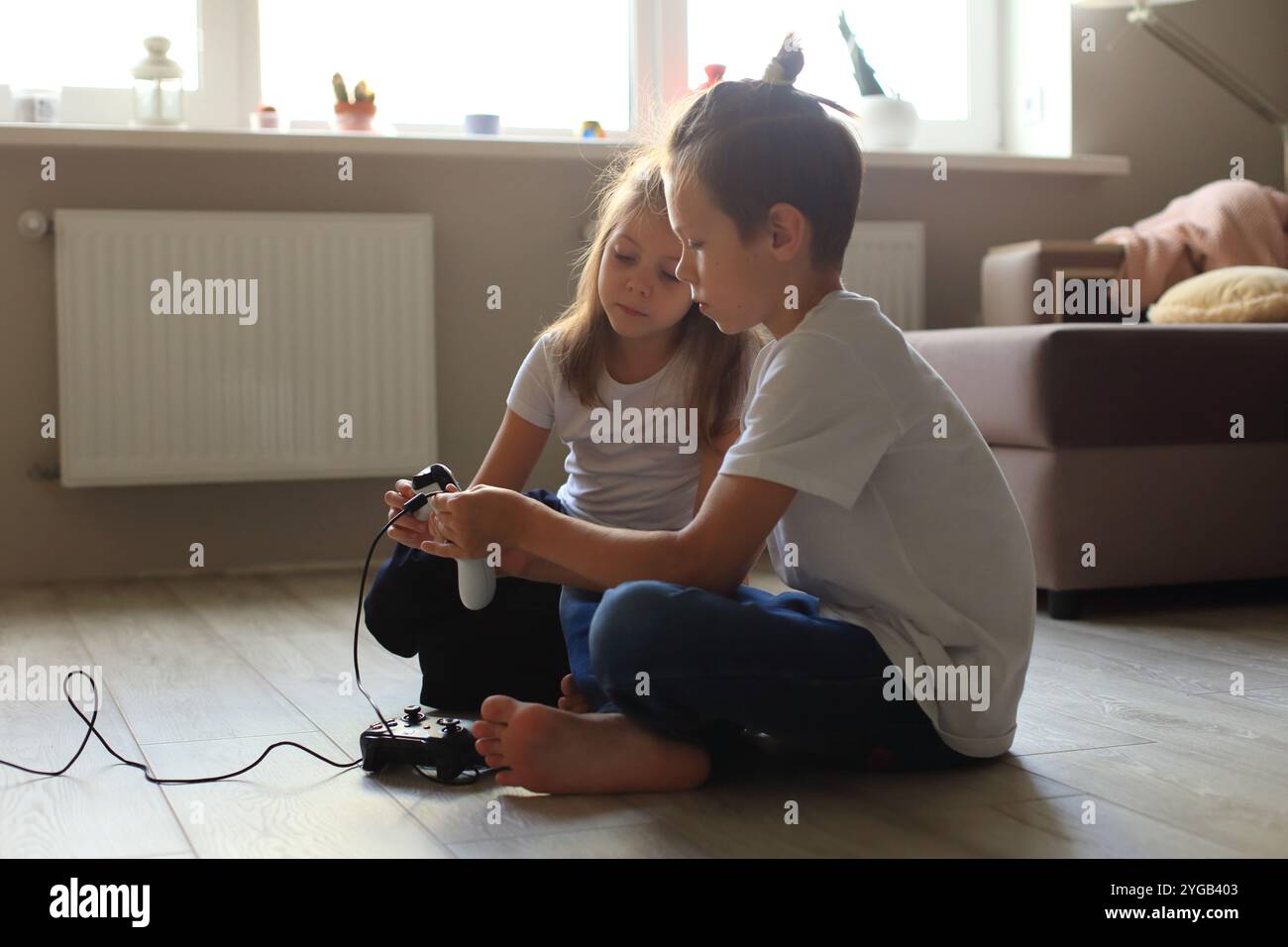 A lively scene of a boy and girl enthusiastically playing video games ...
