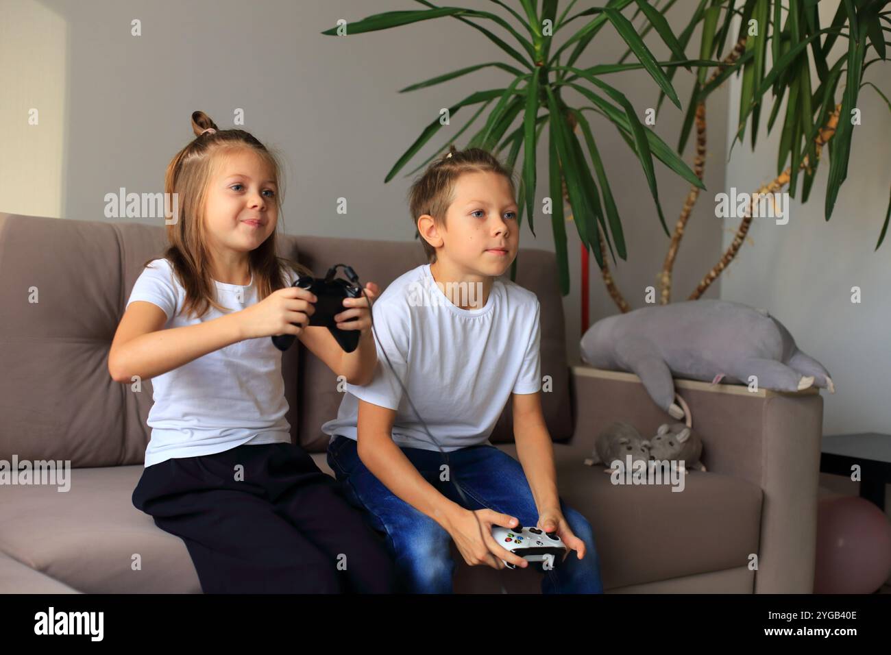 A lively scene of a boy and girl enthusiastically playing video games ...