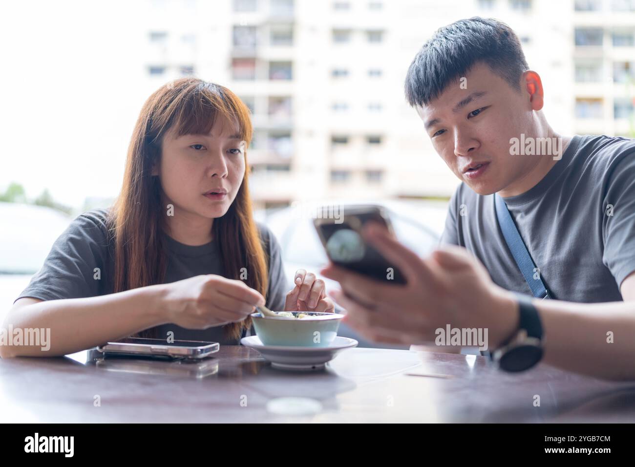 June 2024. A Chinese-Malaysian couple in their 30s chat while eating chendol at a local ...