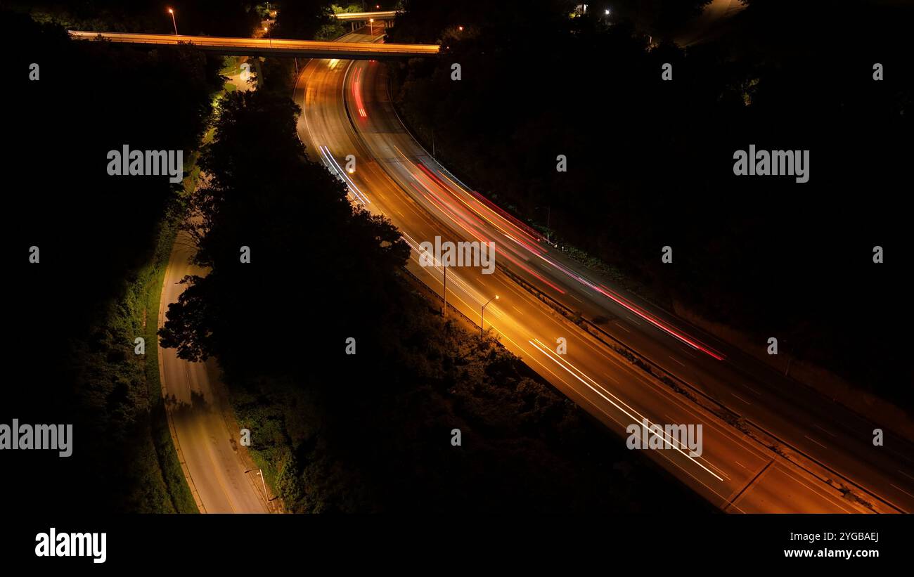 Long-exposure night shots of the cityscape capture vibrant light trails ...