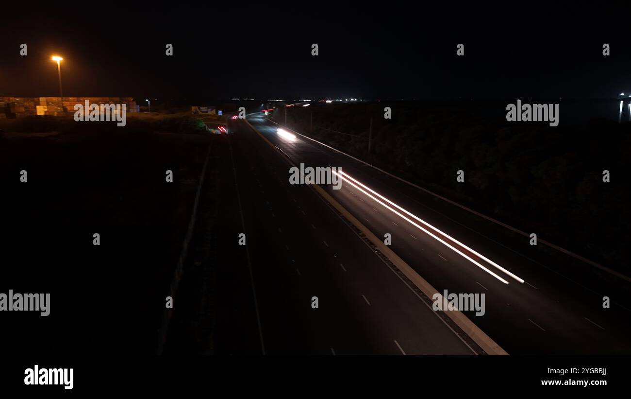 Long-exposure night shots of the cityscape capture vibrant light trails ...