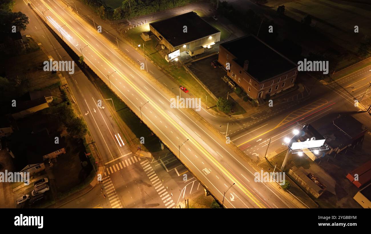 Long-exposure night shots of the cityscape capture vibrant light trails ...