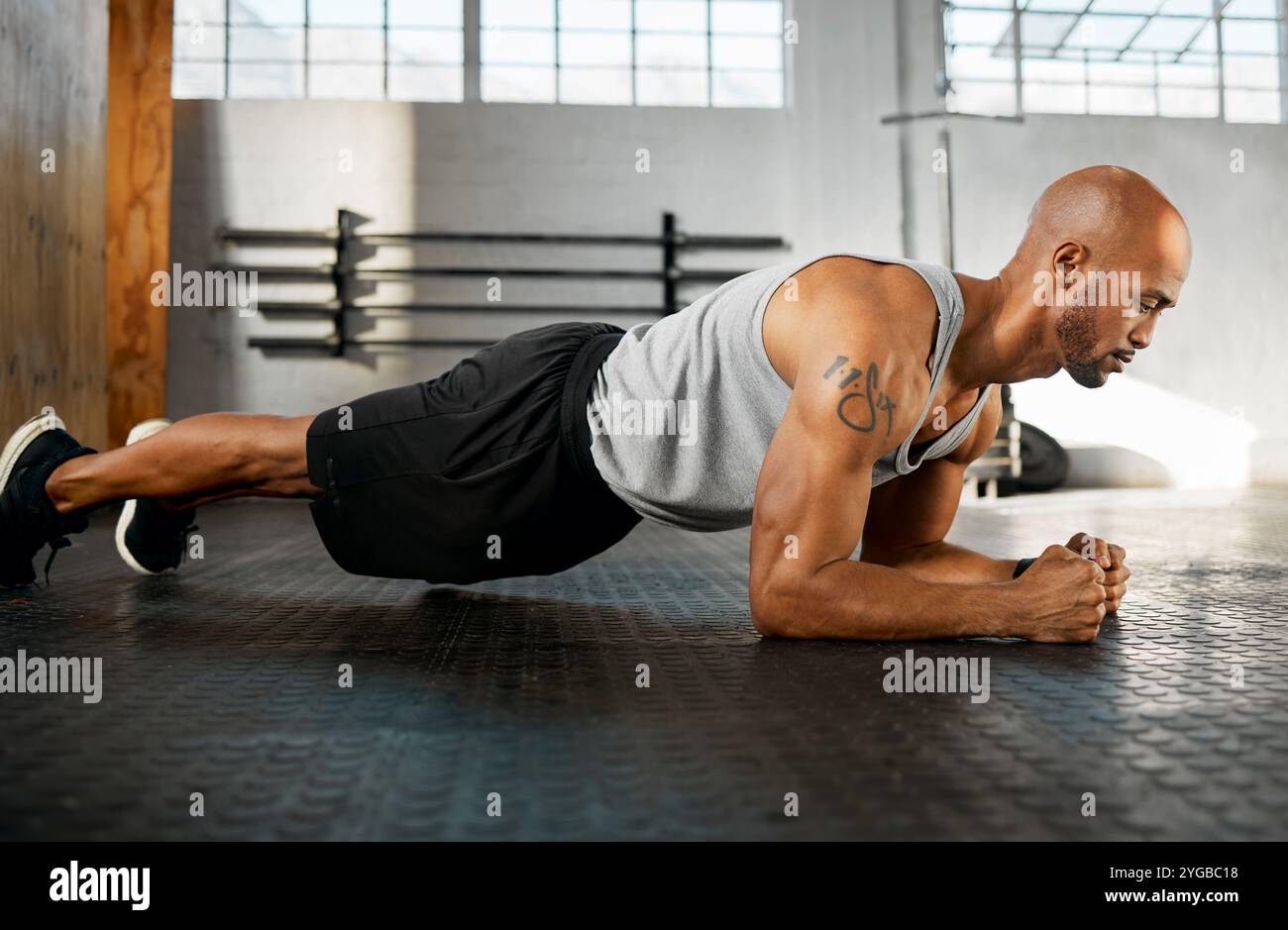 Exercise, fitness and man in gym, serious and plank for strength ...
