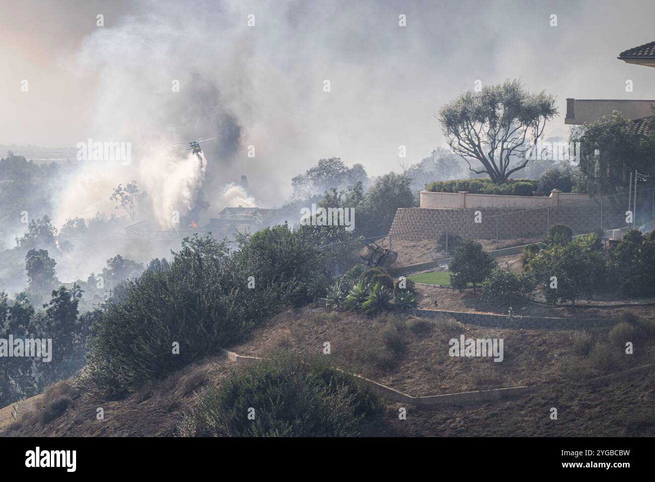 A Coulson helicopter makes a water drop. on the Mountain Fire. The ...