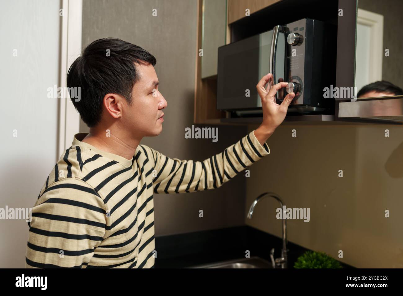 Chinese young man kitchen hi-res stock photography and images - Alamy