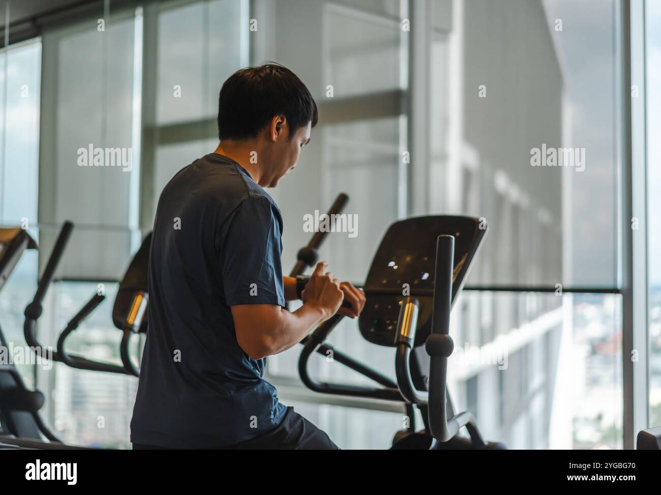 Male trainer checking treadmill performance hi-res stock photography ...