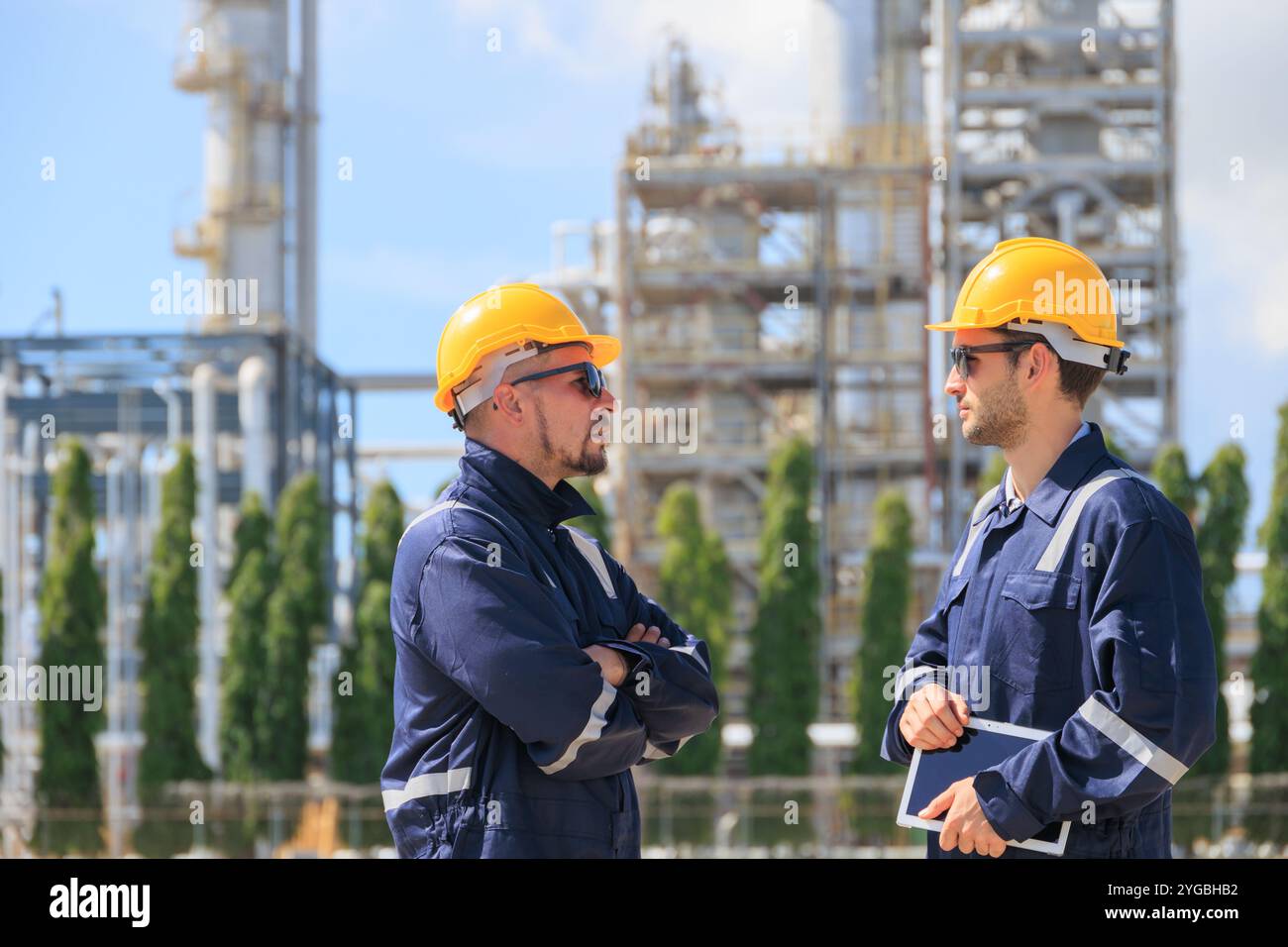 Petroleum industry engineers workers team working outdoor. Refinery oil ...