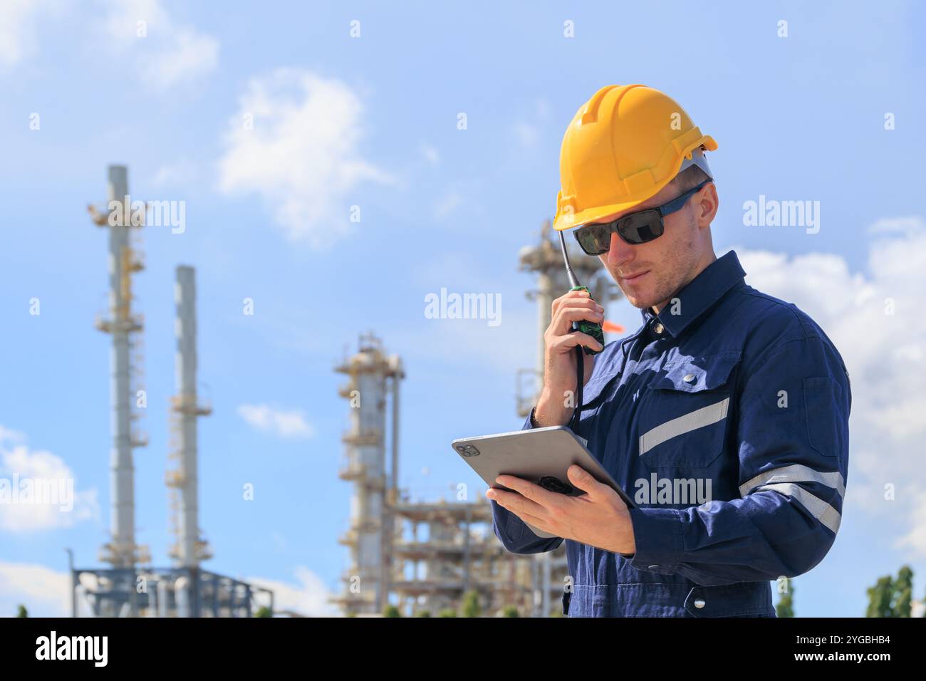 Refinery petroleum worker on duty radio control operation. Industrial ...