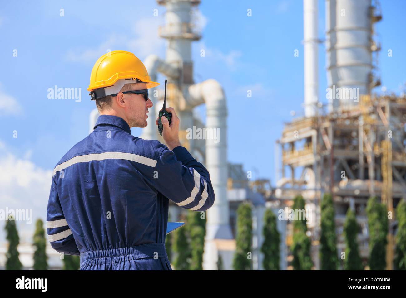 Petroleum Refinery industry engineer male working against oil and gas ...