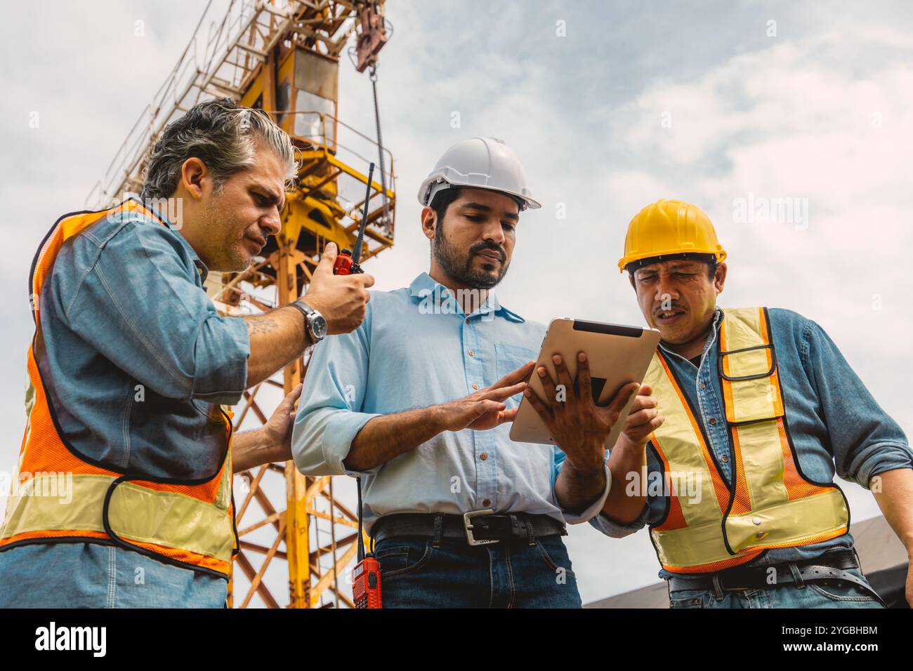 Workers team working together with contractor at construction site ...