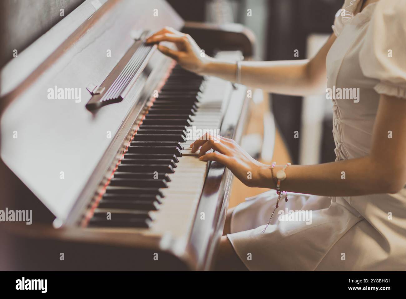 Musician pianist hand opening old wooden piano key brown vintage color ...