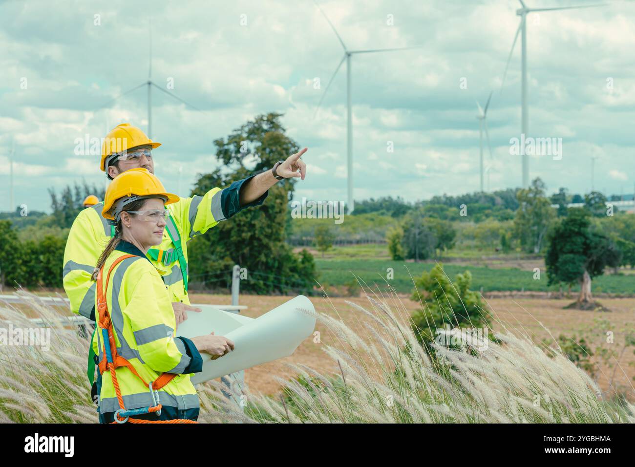 Engineer team man and women workers Wind Turbines service team working ...