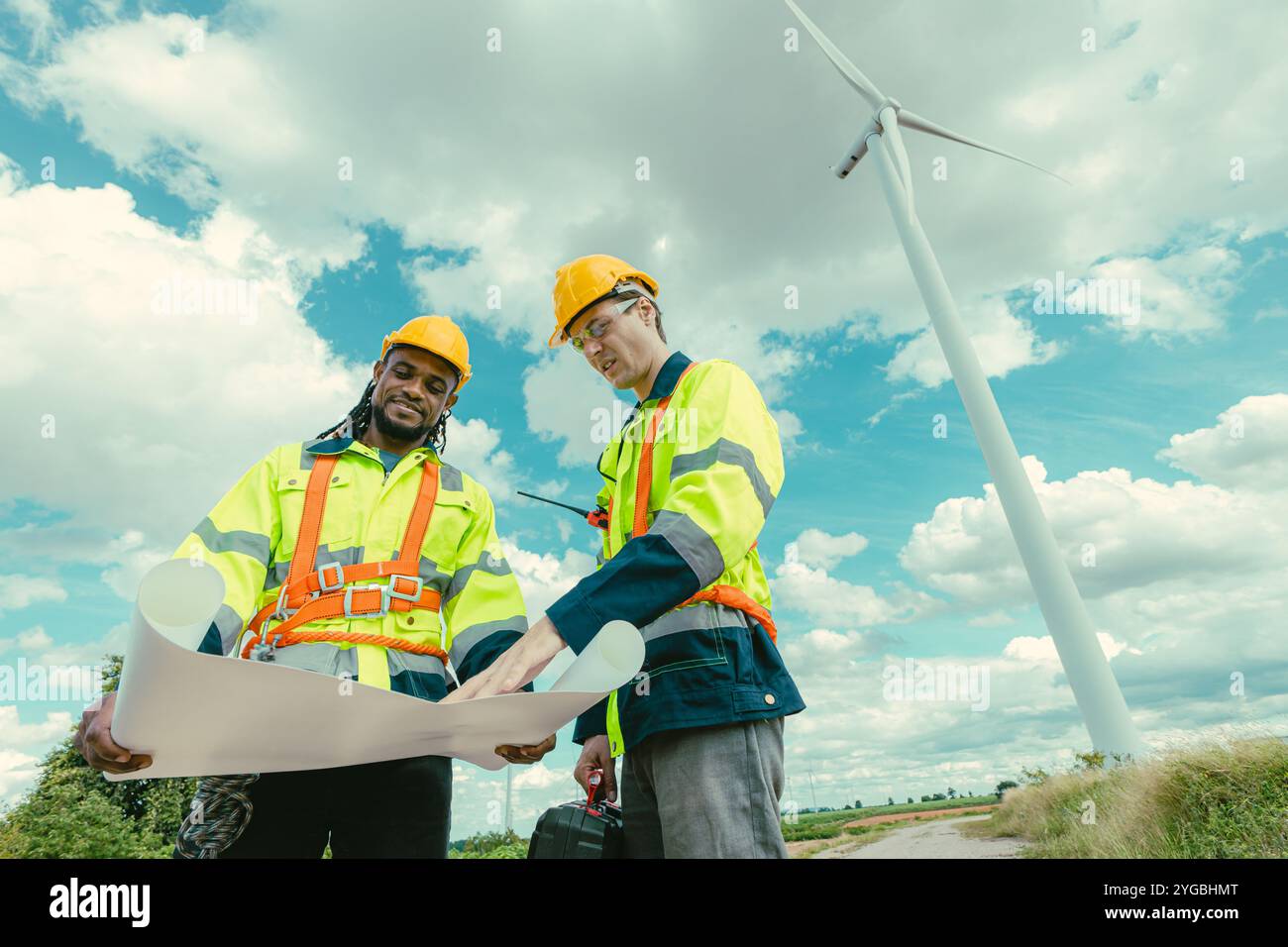 Engineer team mix black and white male workers with floor plan at Wind ...
