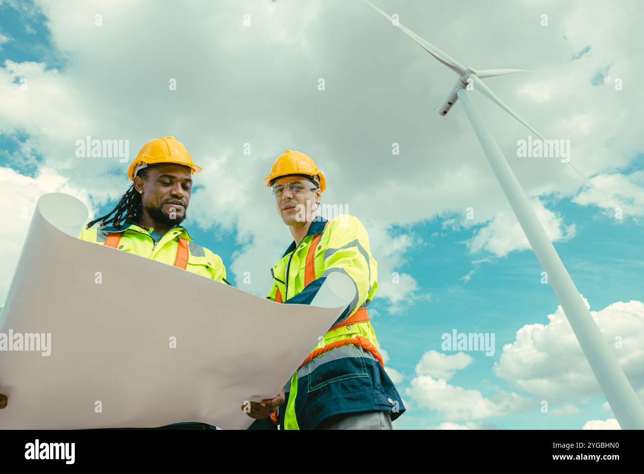 Engineer technician team mix male workers standing at Wind Turbines ...