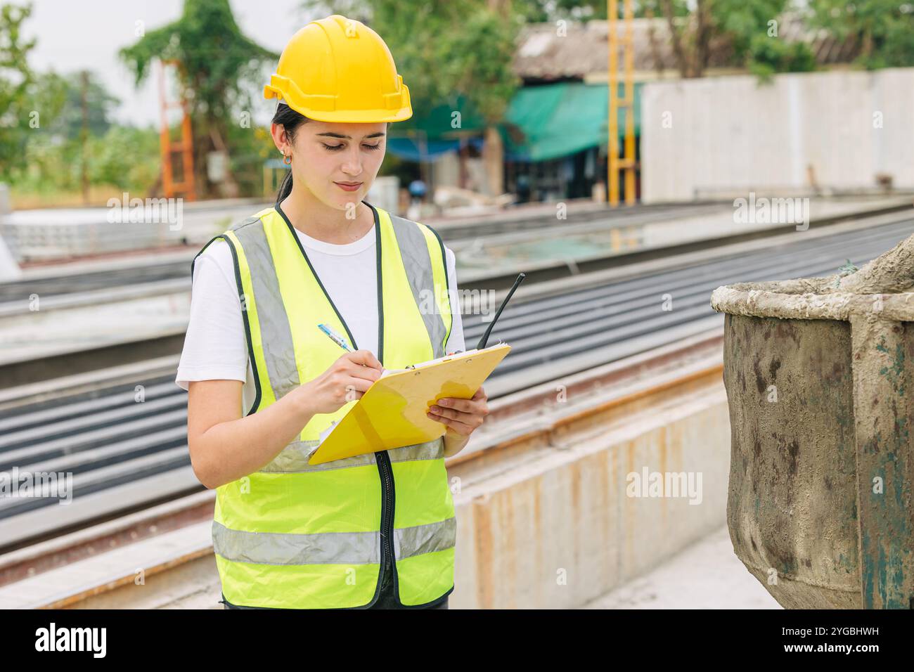 Professional engineer female working in concrete precast plant factory ...