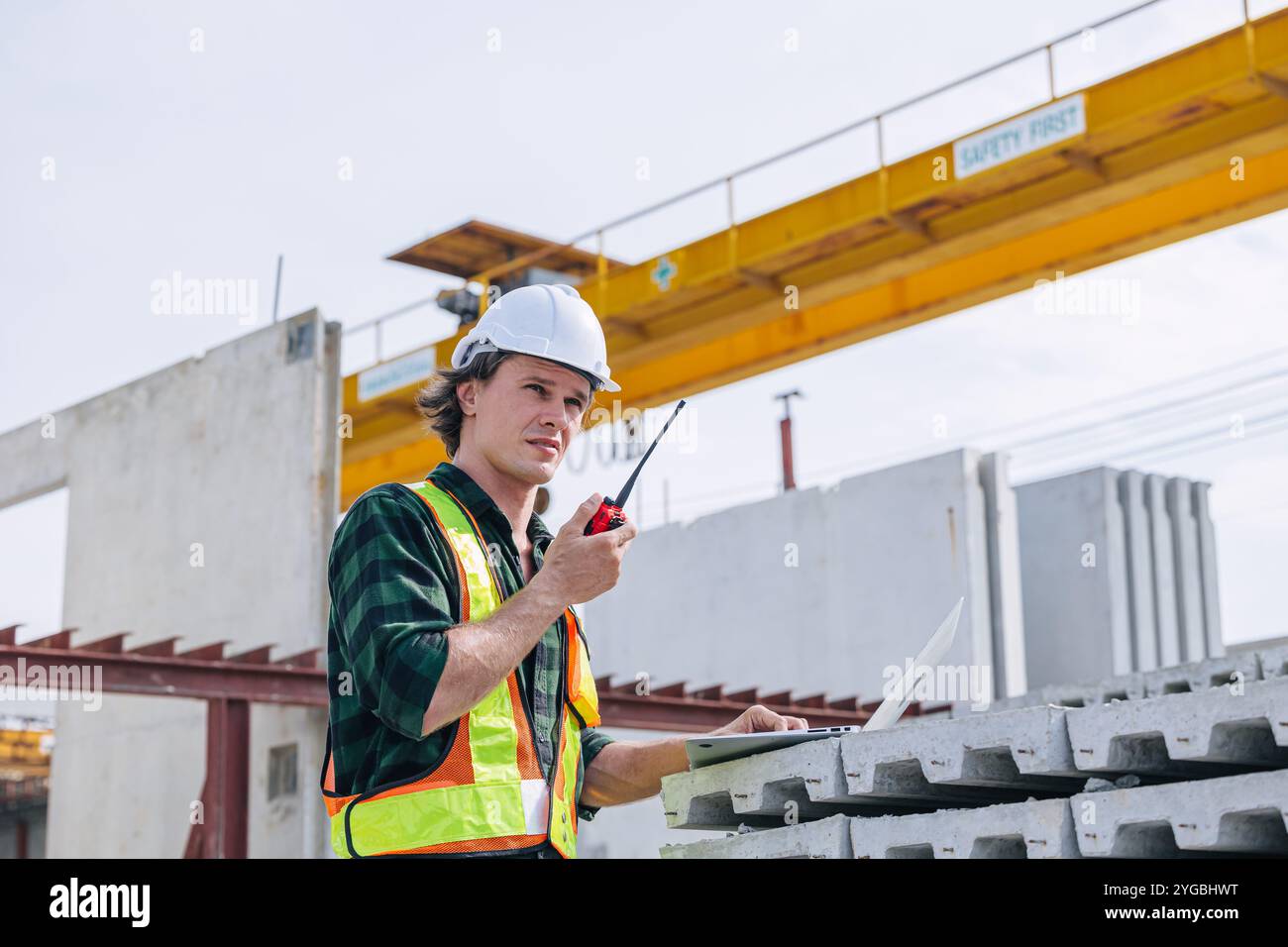 Professional engineer Caucasian male working in concrete precast plant ...