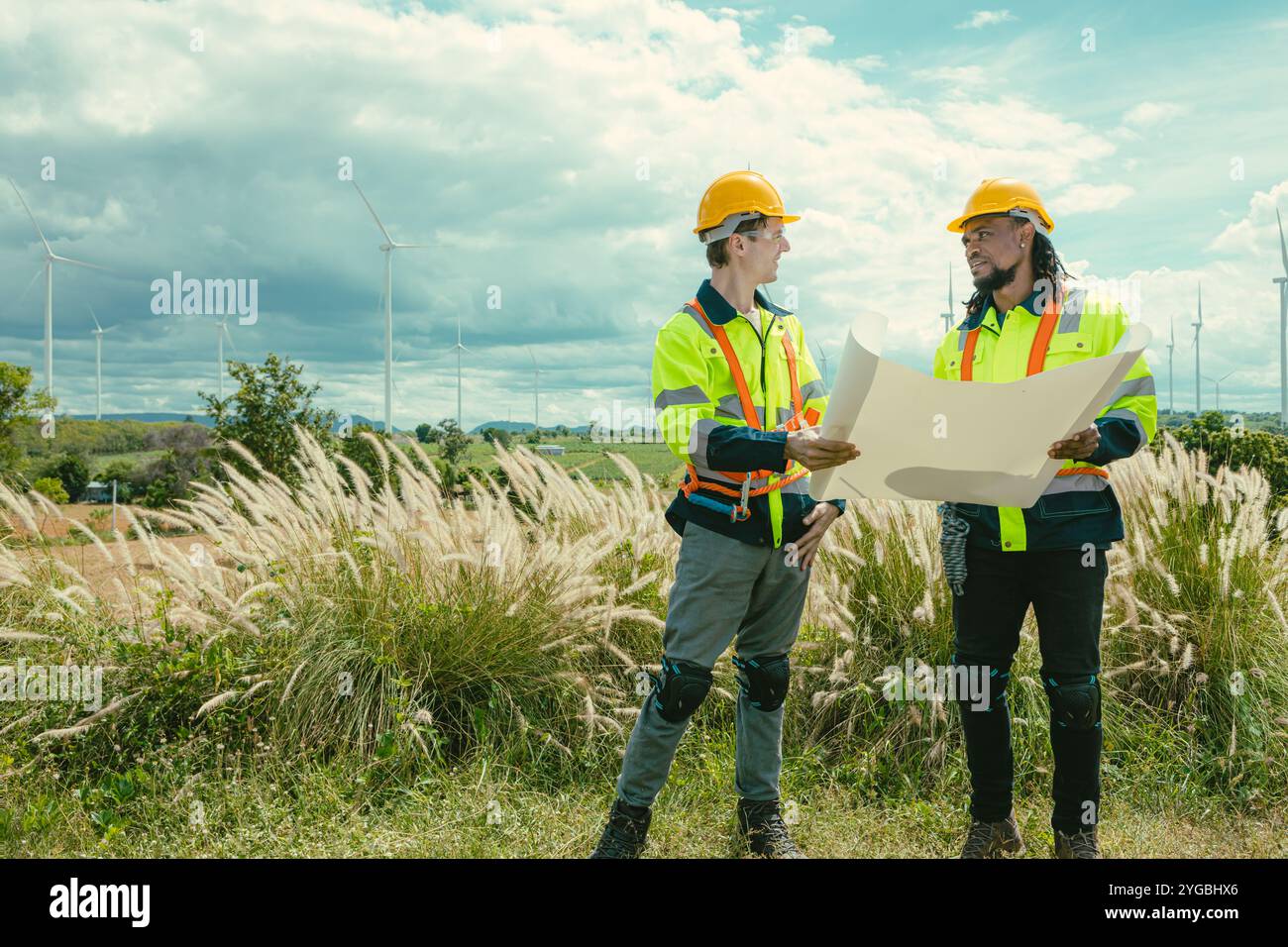 Engineer team mix black and white male workers with floor plan at Wind ...