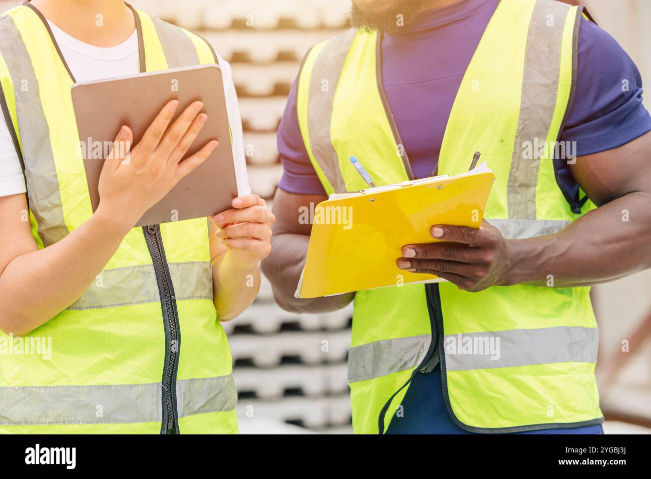 Man and women team workers in reflection safety suit working together ...