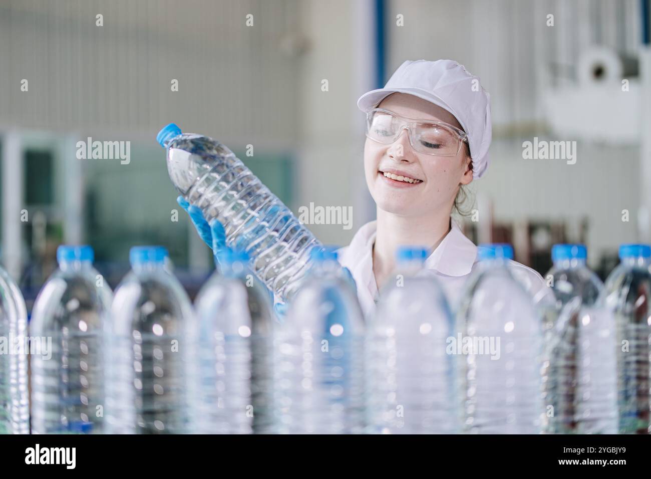 Happy young women worker quality control in Drinking water factory ...