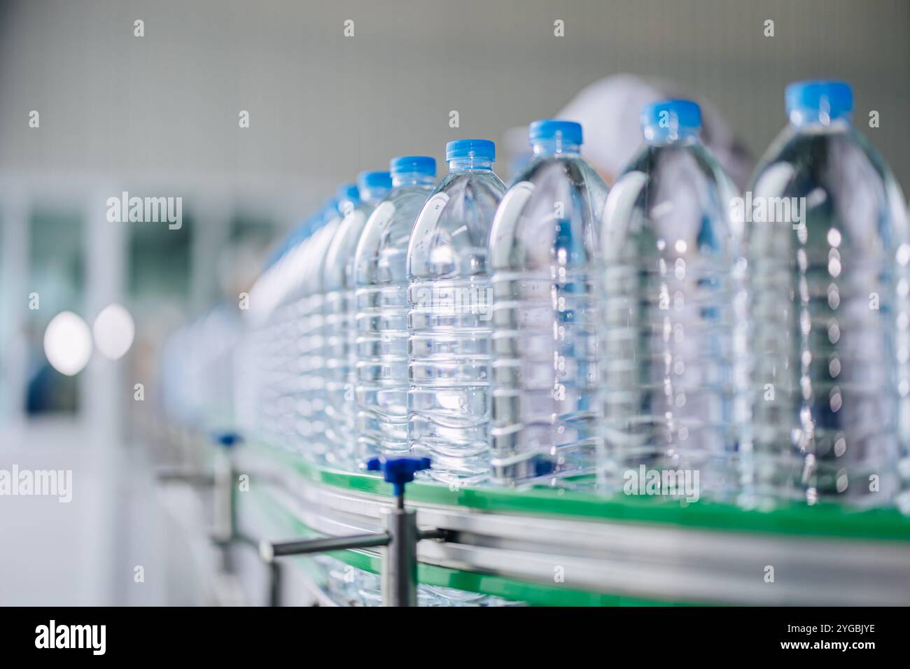 Drinking water production line on conveyor belt. Plastic water bottles ...