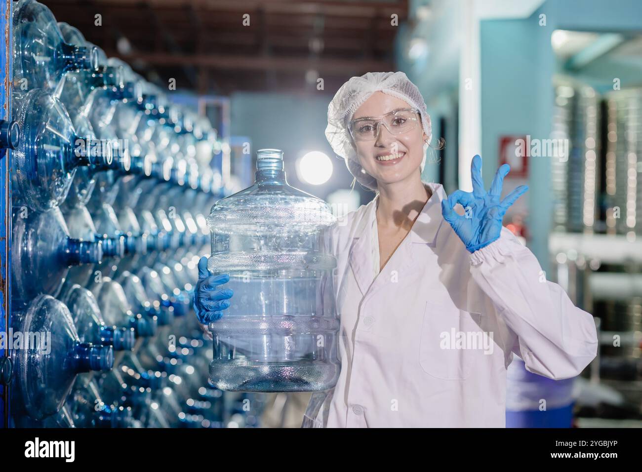 Portrait happy women worker in drinking water factory working check ...