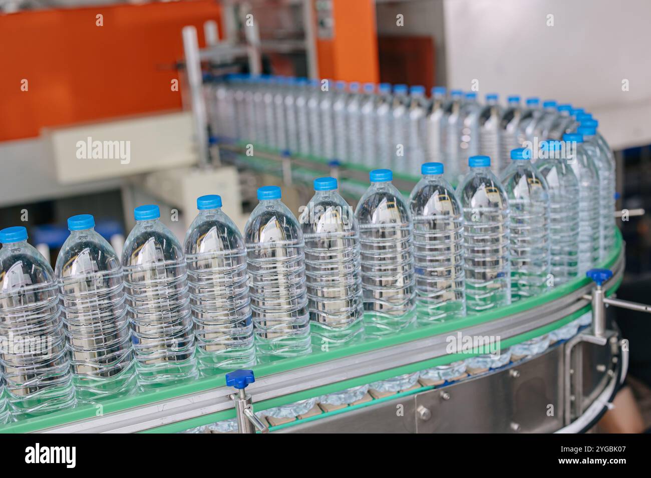Drinking water production line on conveyor belt. Plastic water bottles ...