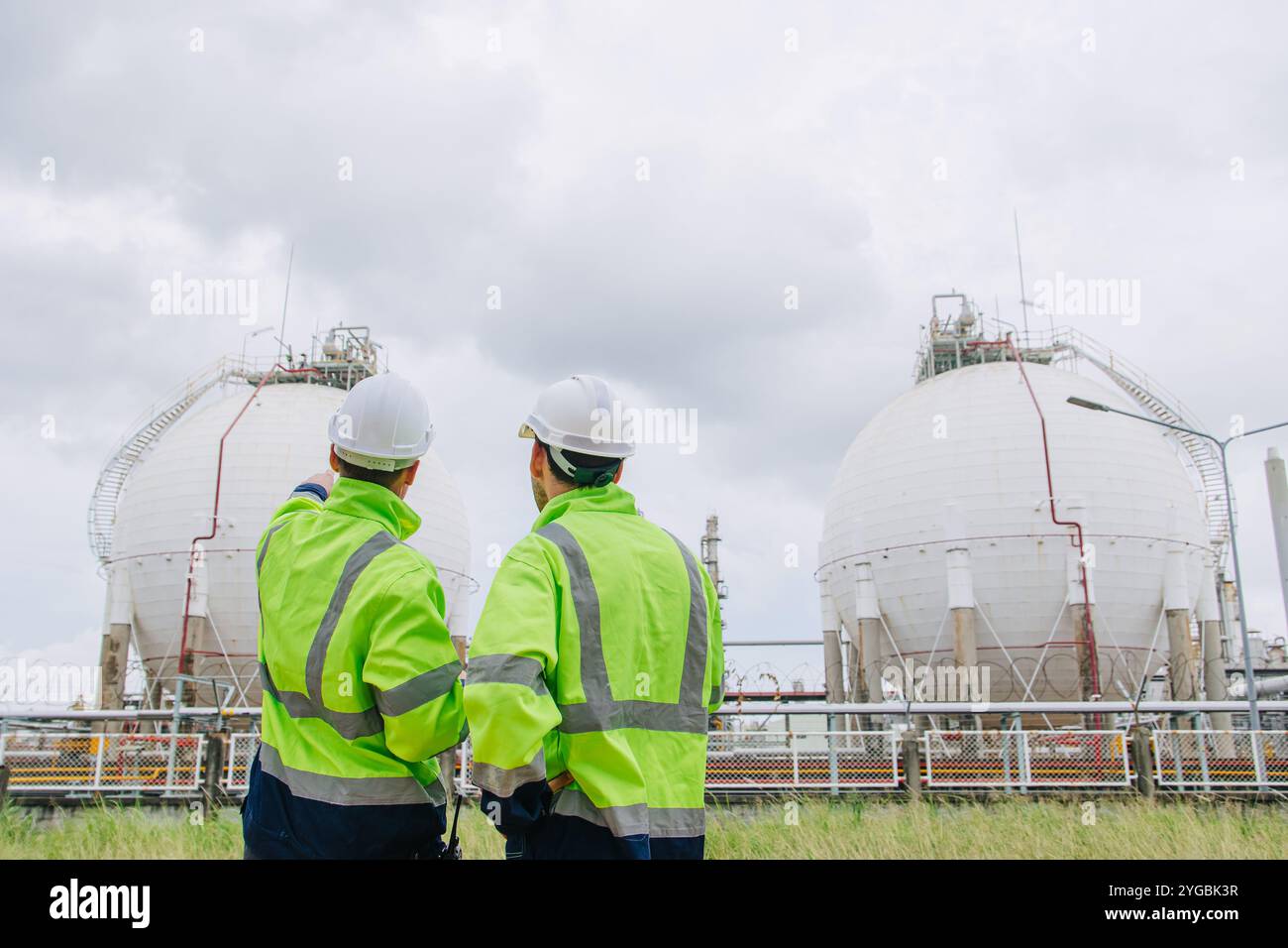 Industrial engineers workers in a refinery oil and gas LNG tank ...