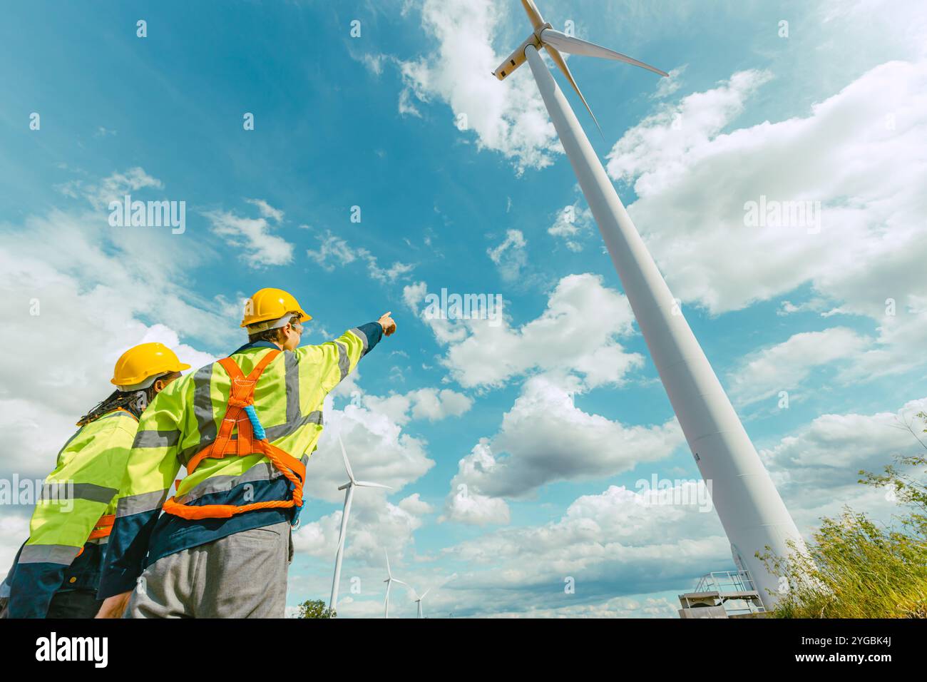 Engineer workers working outdoor with safety at wind turbines clean ...