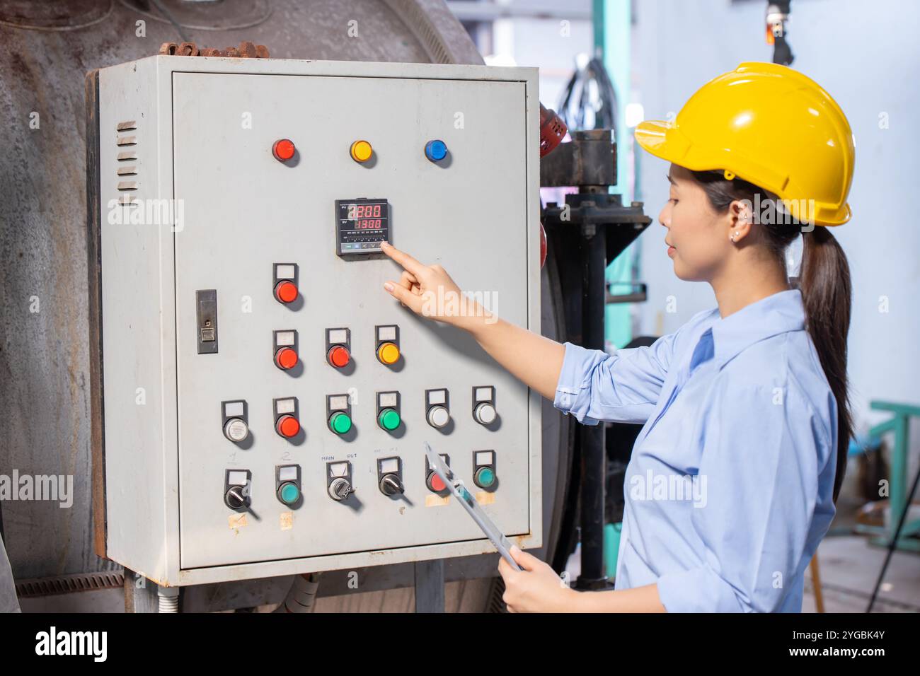 Factory engineer operate control machine pressing control panel monitor ...