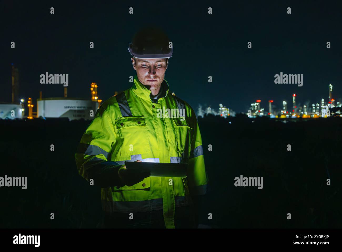 Night shift engineer oil and gas refinery service, male worker hard ...