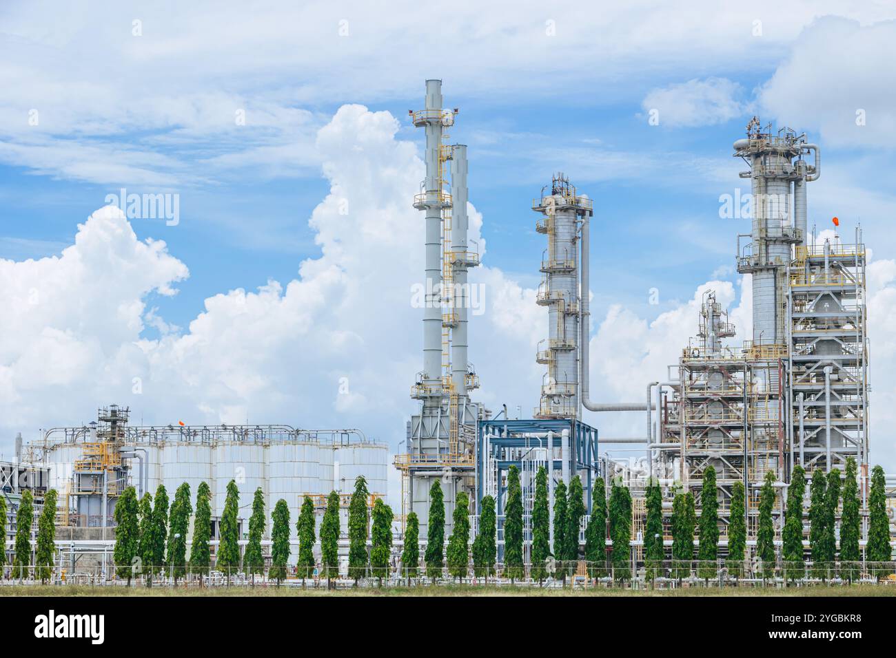 Green petrochemical Industrial, Refinery plant with tree blue sky ...