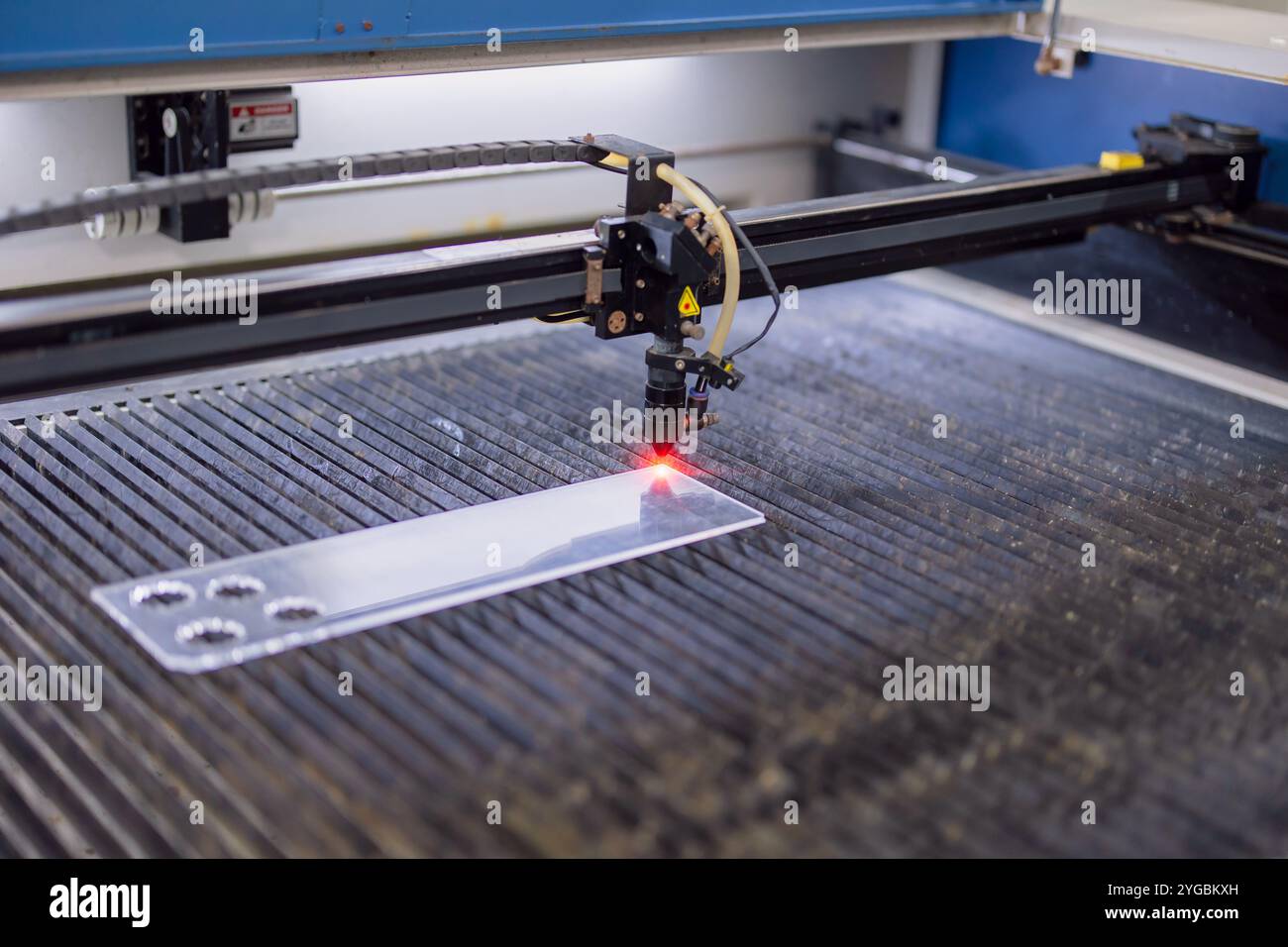 Closeup industrial CO2 laser cutting machine working with high powered ...