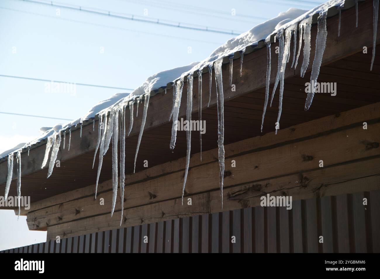 Water droplets are ice dripping from the roof of a house Stock Photo ...