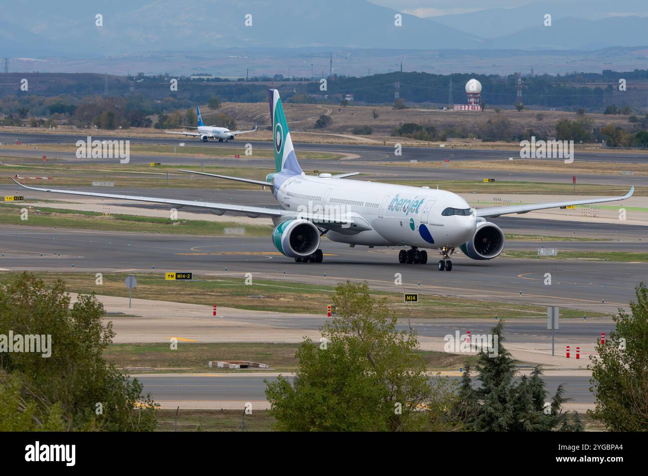 Madrid Barajas Airport. Modern airliner A330 900 neo of the Iberojet airline maneuvering after ...
