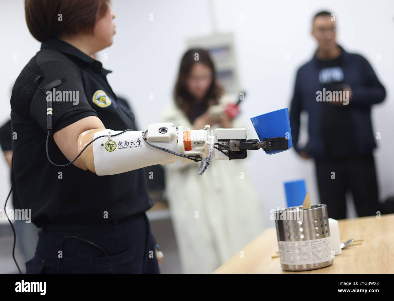 Disabled athlete Xu Min (left) demonstrates the function of the 'human ...