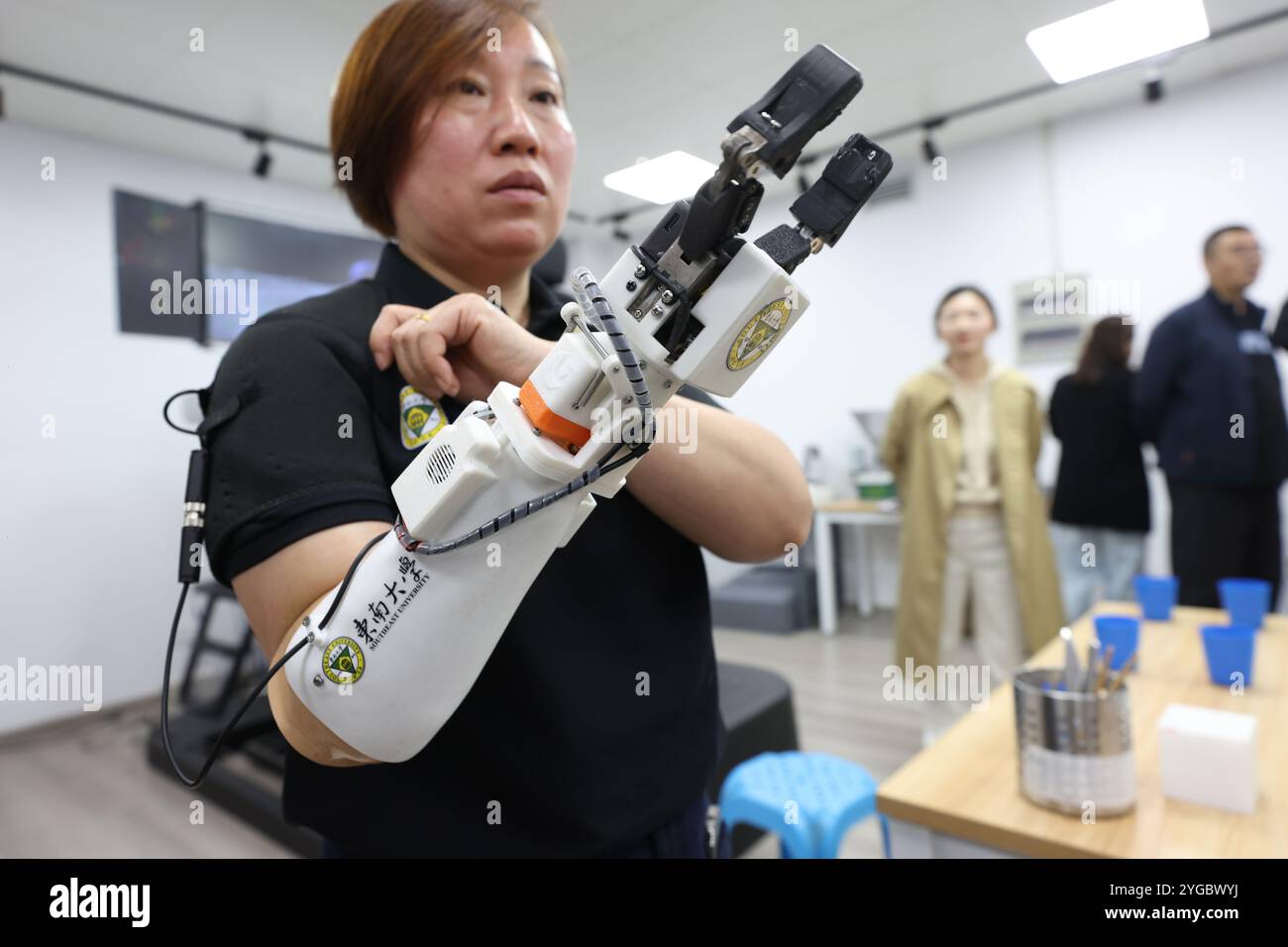 Disabled athlete Xu Min (left) demonstrates the function of the 'human ...