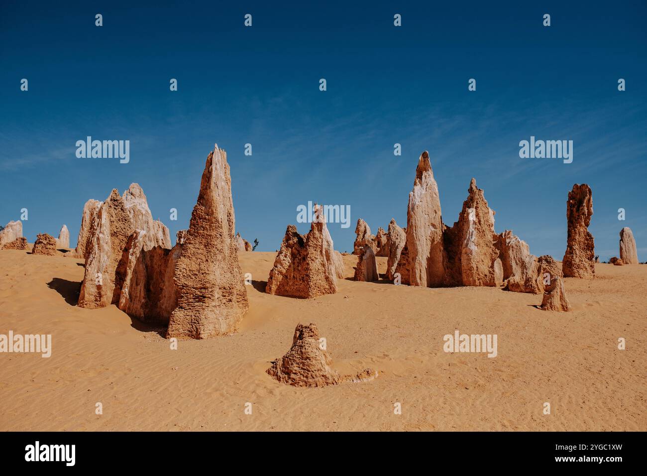 Yellow desert sand and weathered limestone pillar formations in The ...