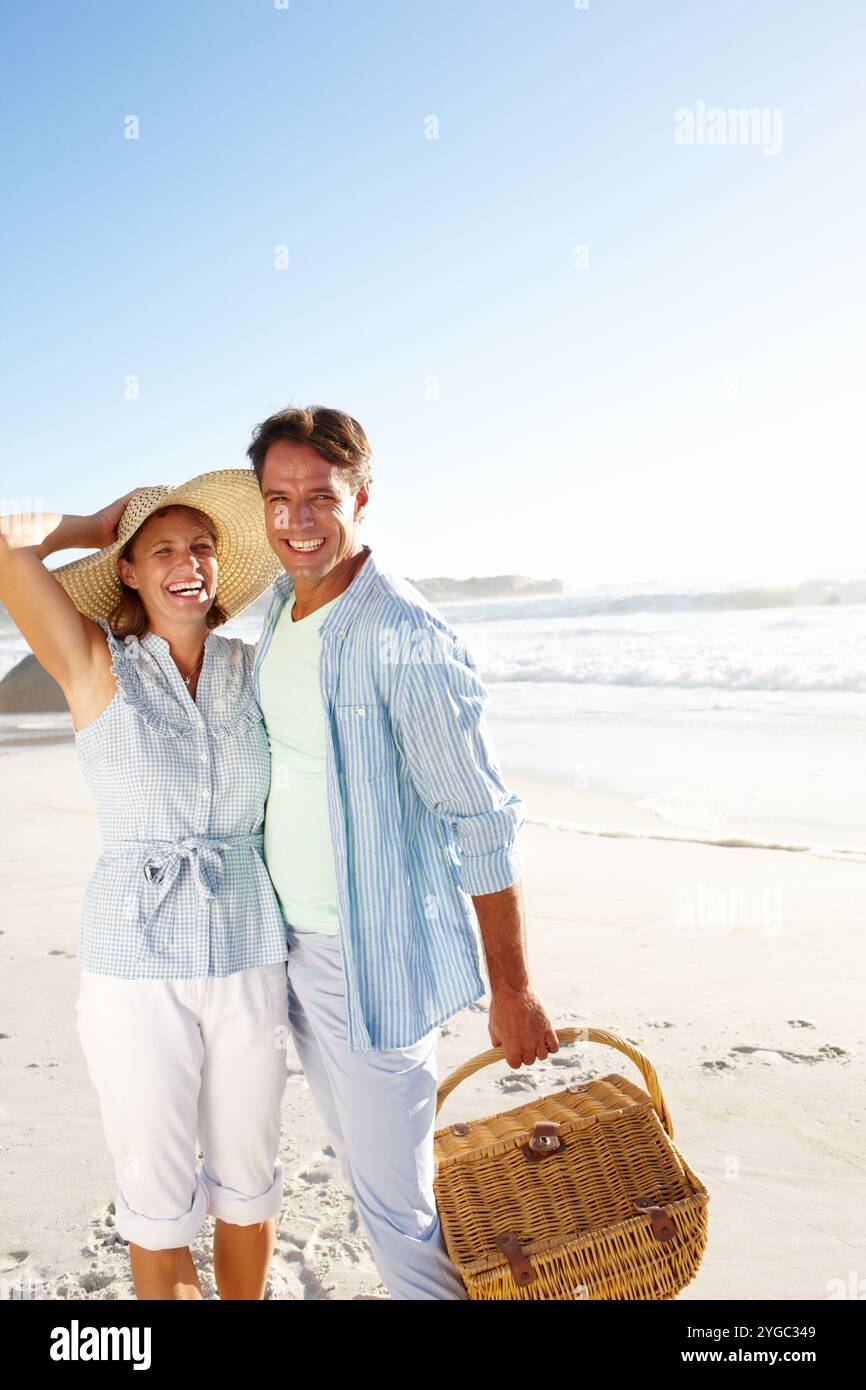 Portrait, beach and mature couple with picnic, basket and love for ...