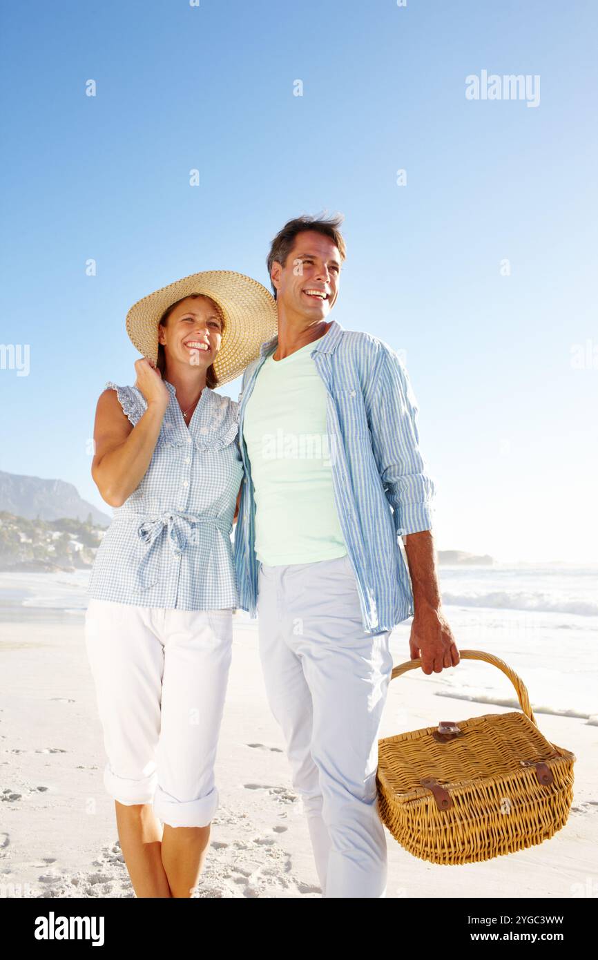 Thinking, beach and mature couple with picnic, basket and love for ...