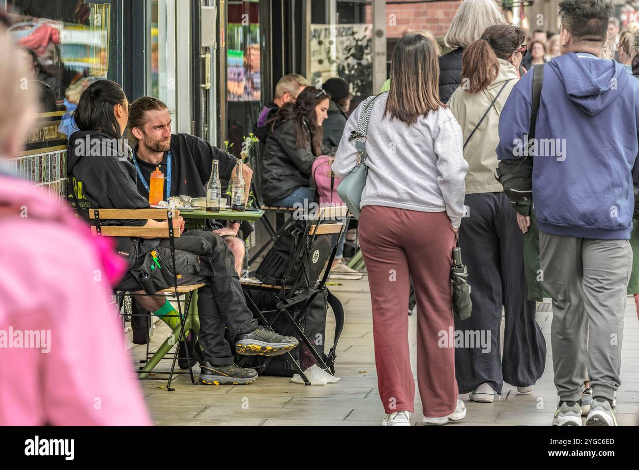 Everyday Life. Couple in outside café surrounded by crowd. Dublin ...